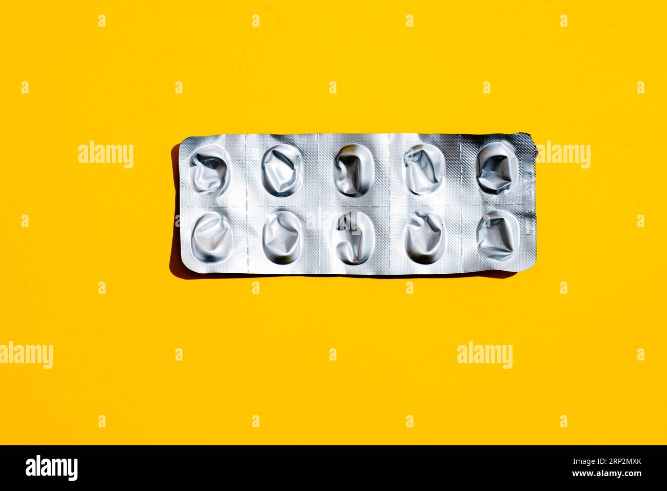 Empty tablet blister pack against yellow background, top view Stock ...