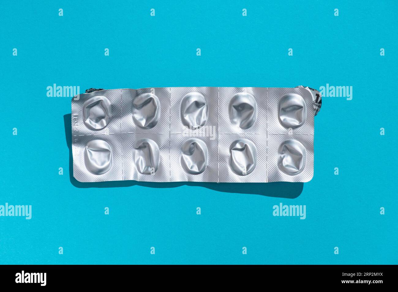 Empty tablet blister pack against a monochrome background, top view ...