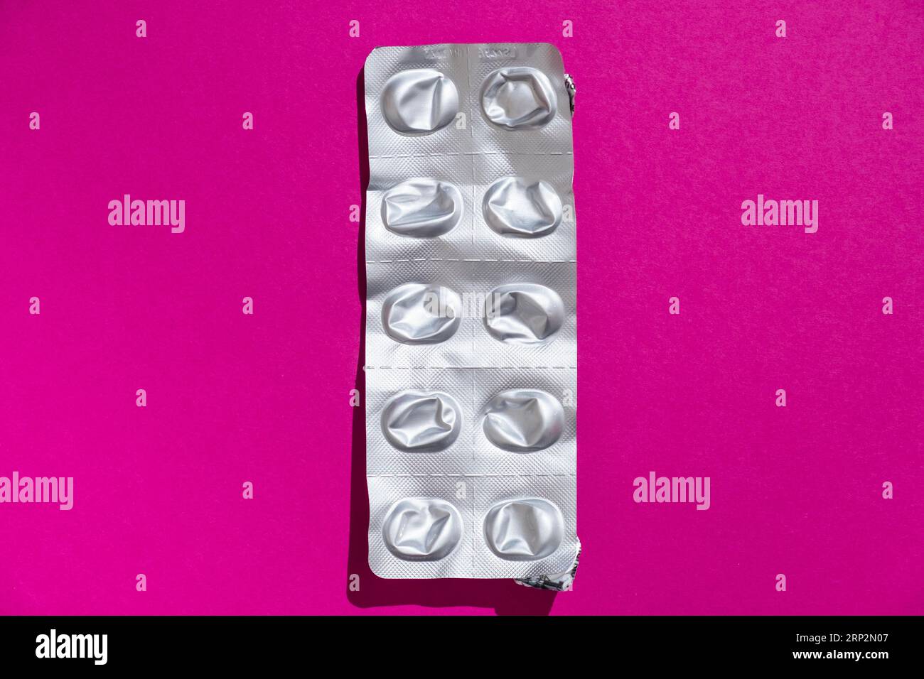 Empty tablet blister pack against a monochrome background, top view ...
