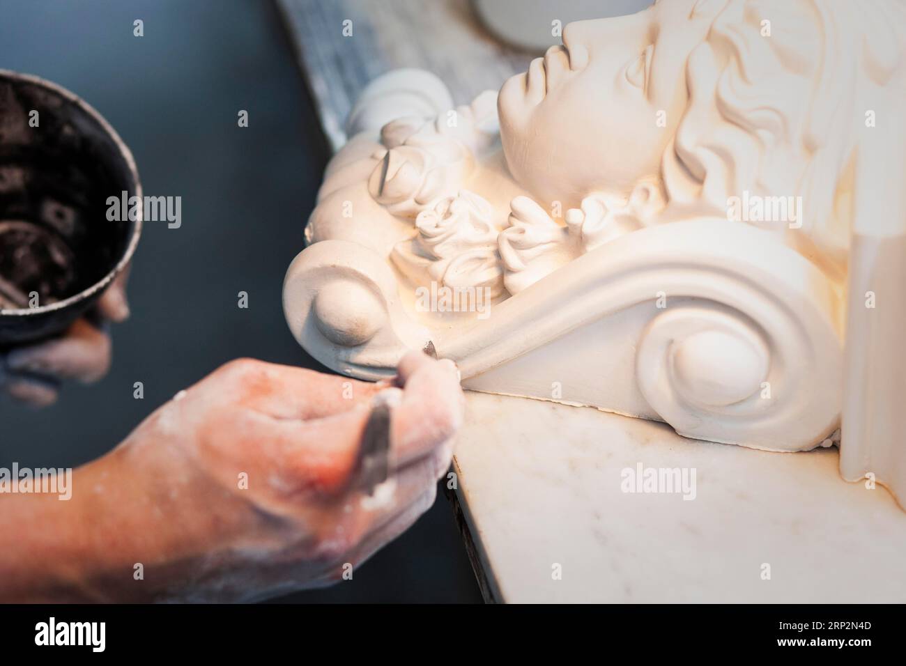 A plasterer restores a stucco figure Stock Photo - Alamy