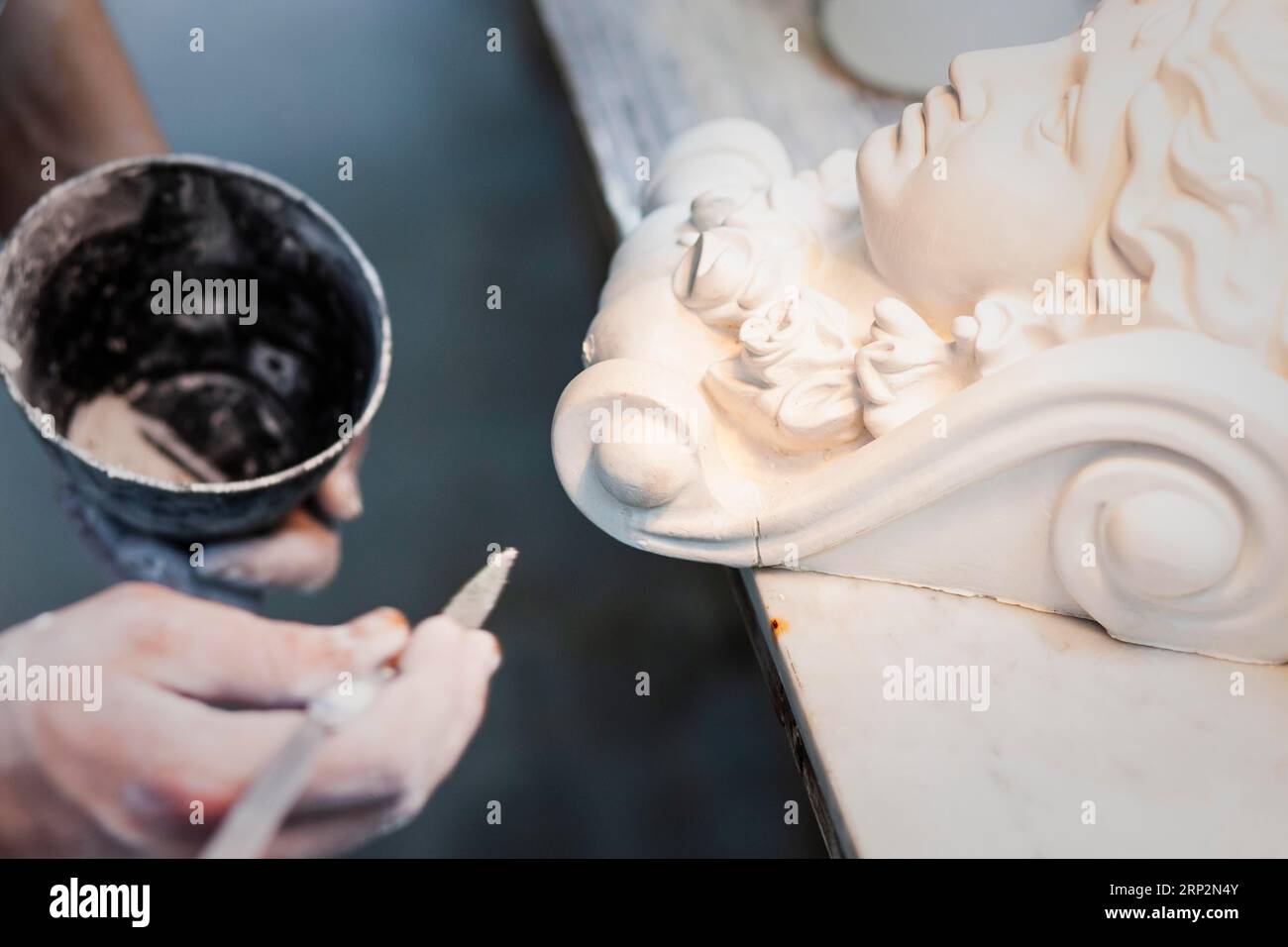 A plasterer restores a stucco figure Stock Photo - Alamy