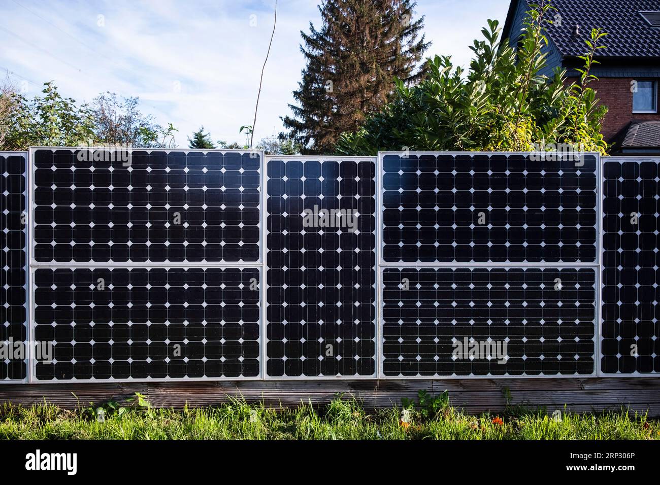 Solar panels as a garden fence and privacy screen of a house on a ...