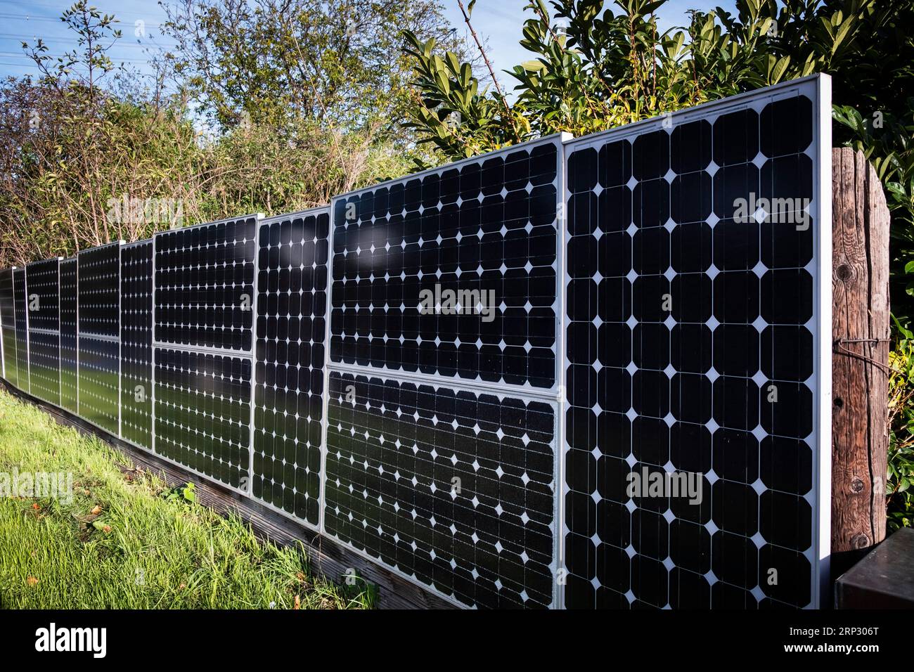 Solar panels as a garden fence and privacy screen of a house on a ...