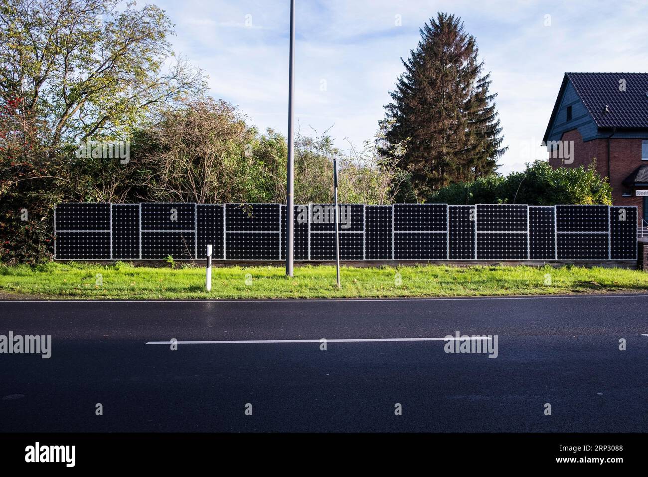 Solar panels as a garden fence and privacy screen of a house on a ...