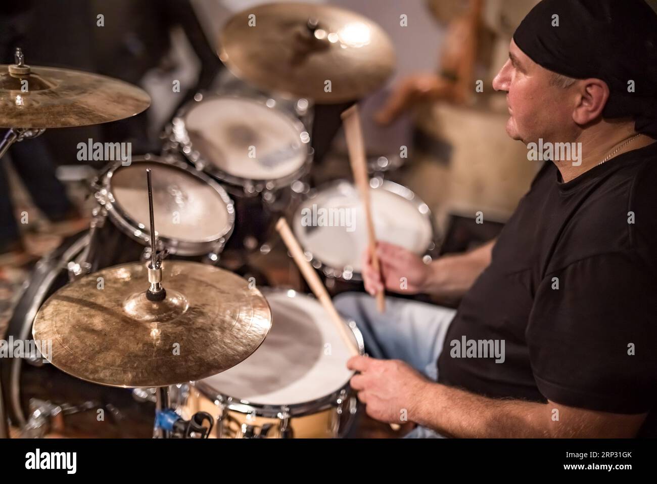 Drummer playing on drum set on stage Stock Photo - Alamy