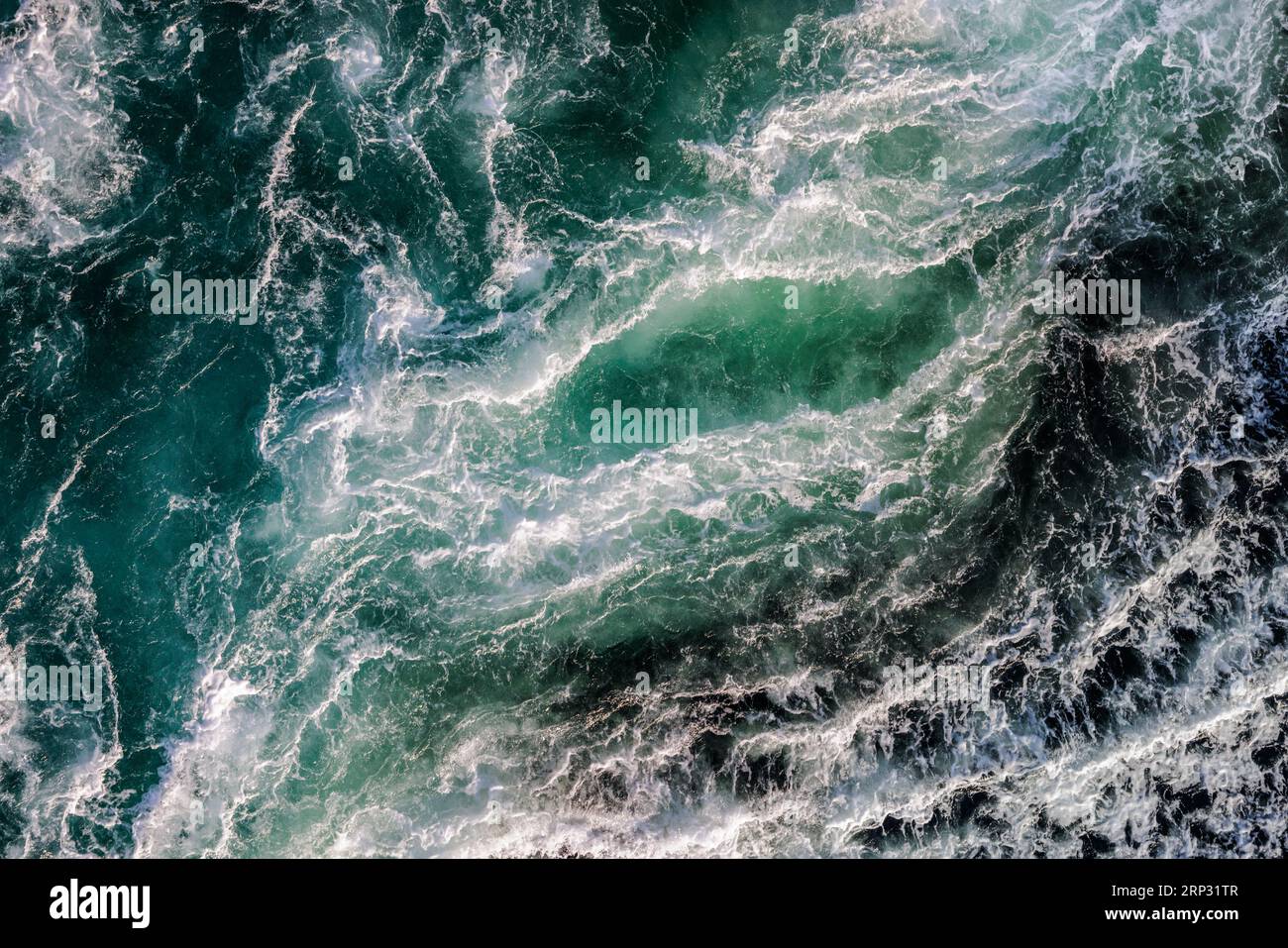 Blue waves of water of the river and the sea meet each other during ...