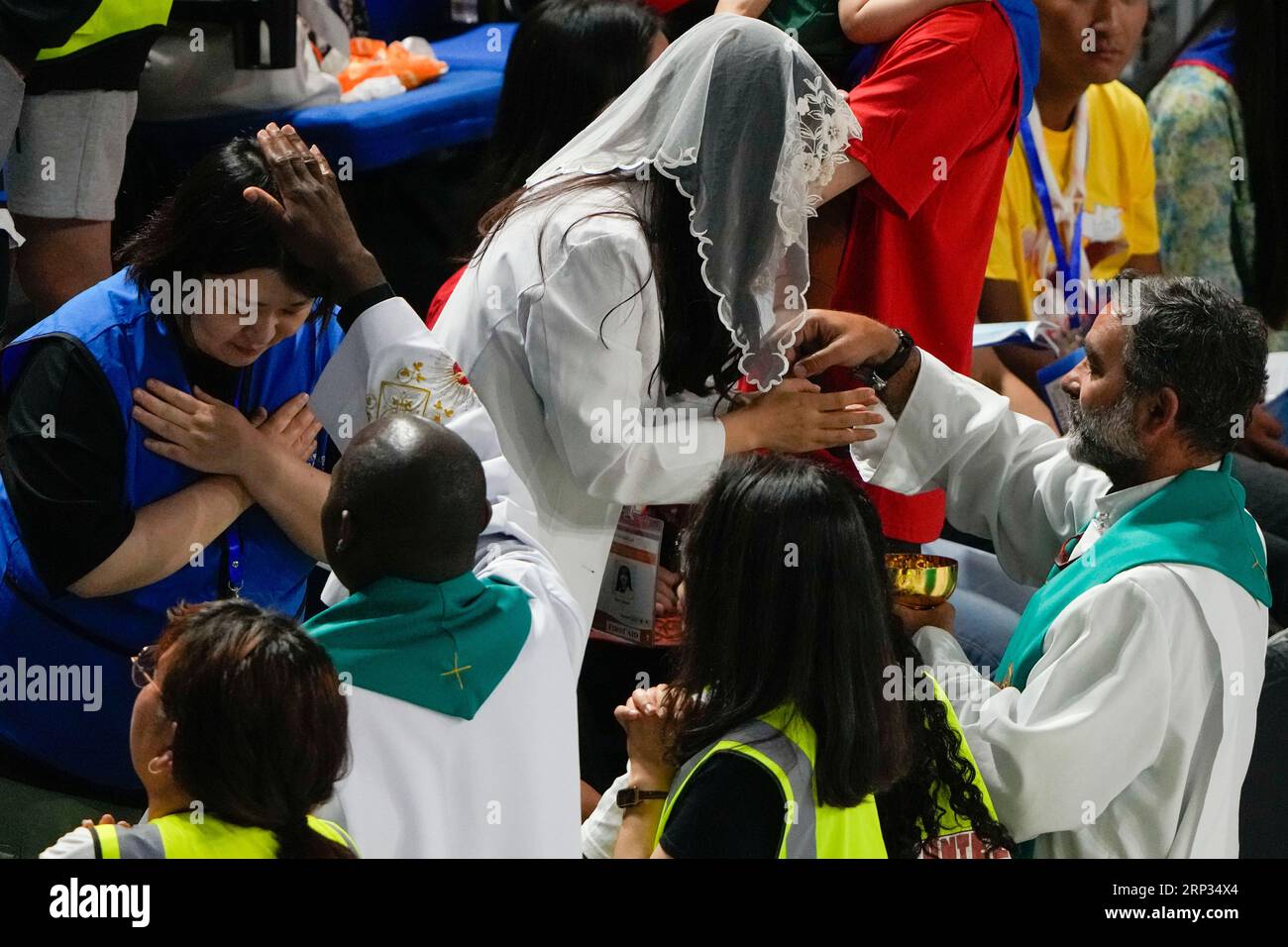 Participants receive the holy communion during a mass presided over by ...