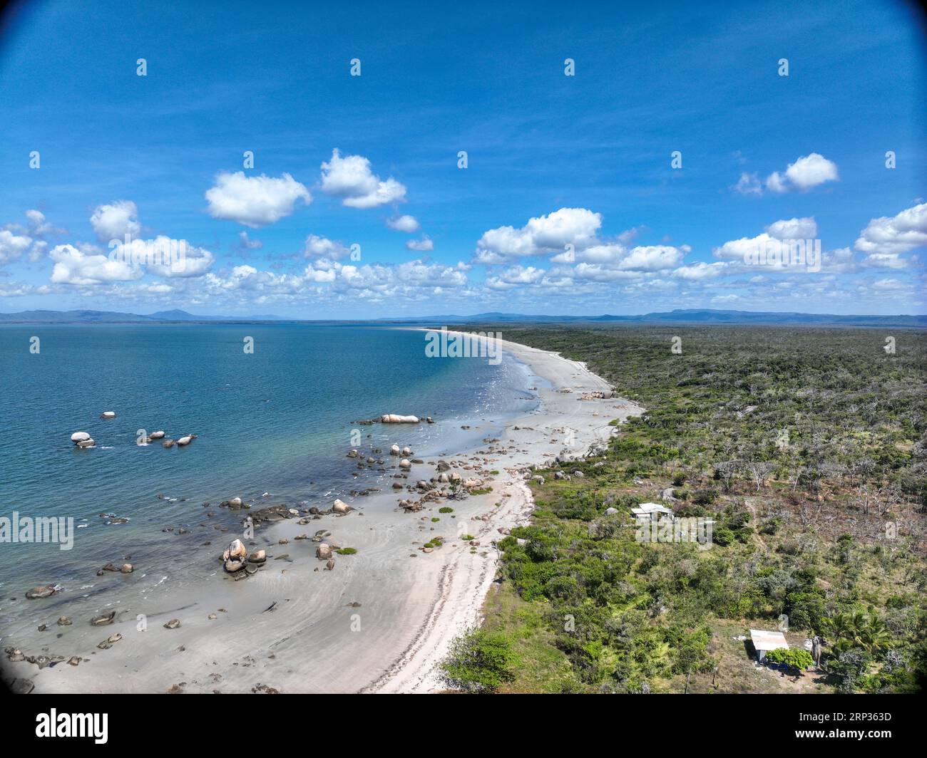 Aerial view of white rippling sandy beach and blue clear water in ...