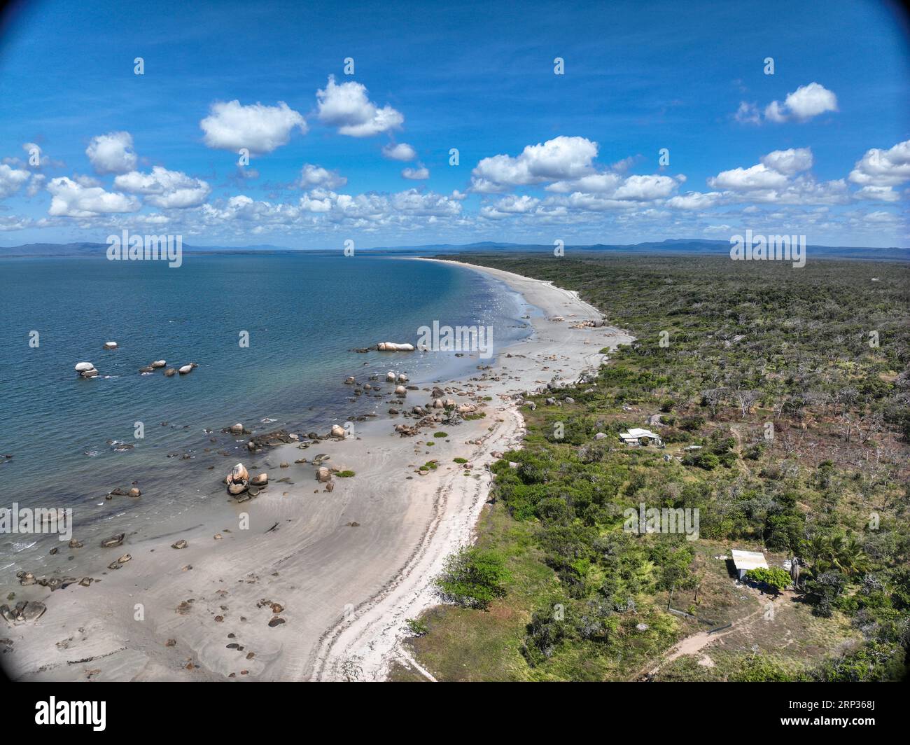 Aerial view of white rippling sandy beach and blue clear water in ...