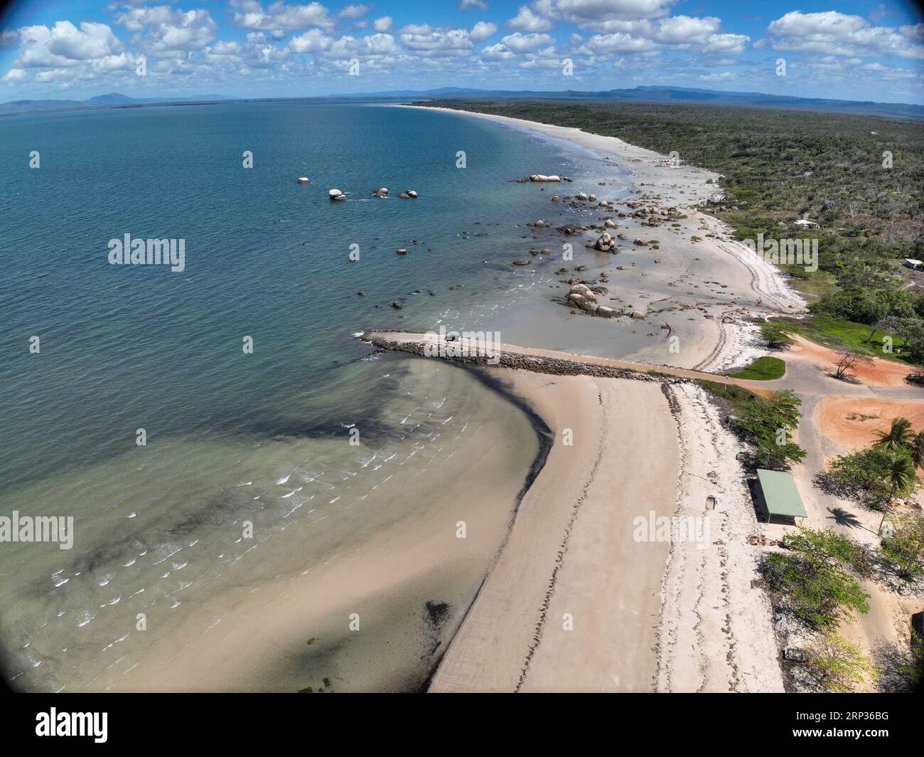 Aerial view of white rippling sandy beach and blue clear water in ...