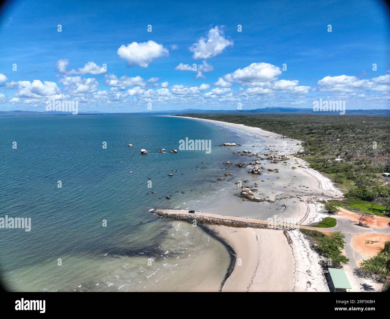 Aerial view of white rippling sandy beach and blue clear water in ...