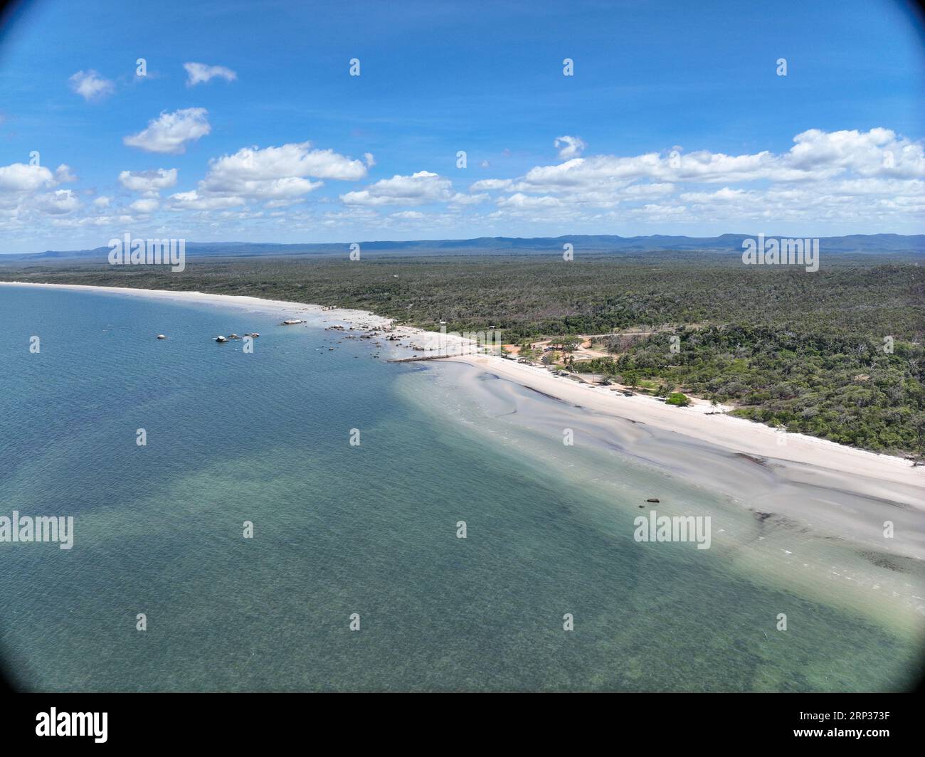 Aerial view of white rippling sandy beach and blue clear water in ...