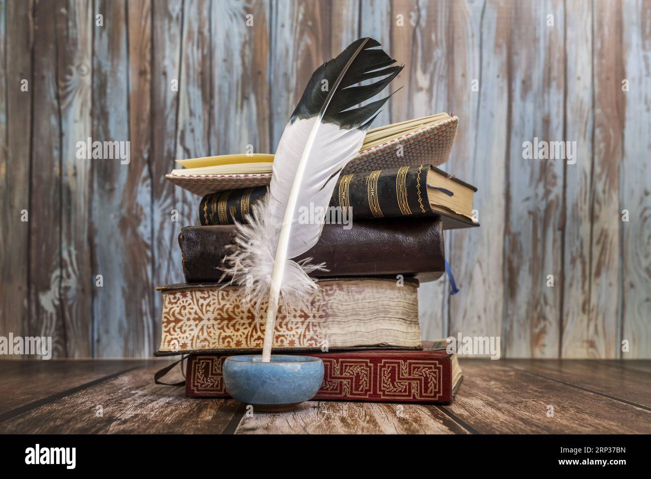 A stack of vintage books along with an old writing pen with ink Stock ...