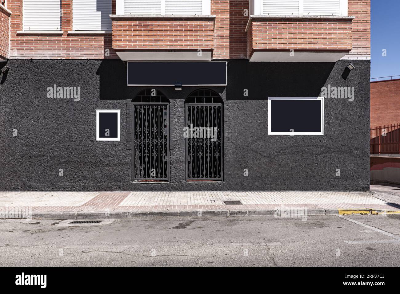 A commercial premises at the street door with a black painted façade ...