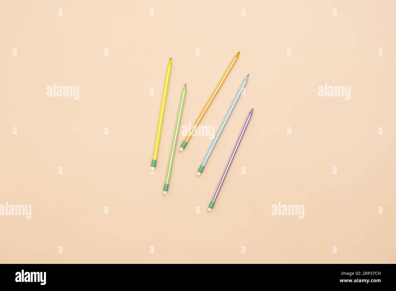 A few assorted colored graphite lead pencils with small erasers on one ...