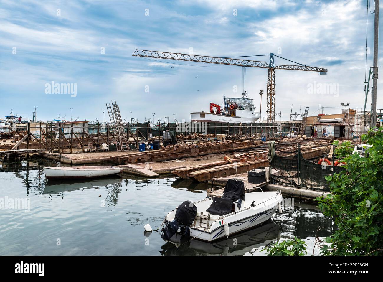 Shipyard and fishing ships in the port of Sciacca, fishing village in ...