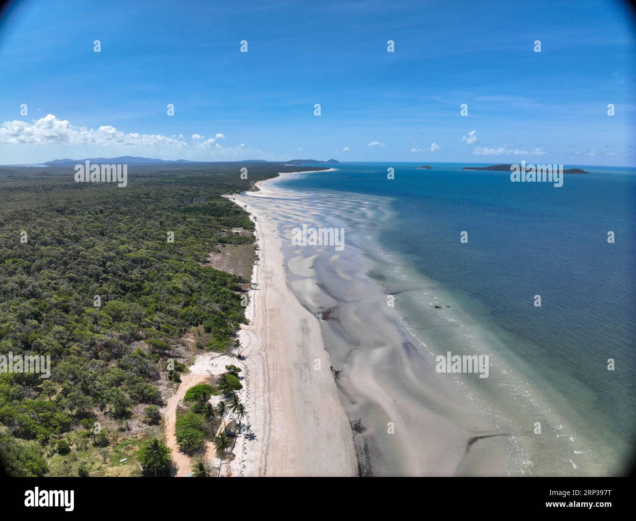 Aerial view of white rippling sandy beach and blue clear water in ...