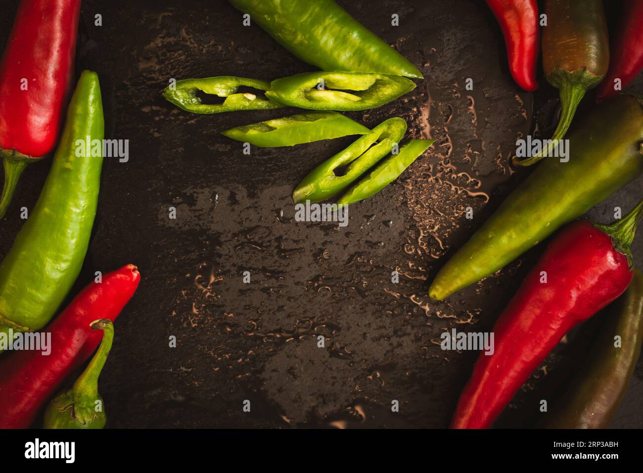 Red hot chilli peppers on black board with copy space. Heap of red and ...