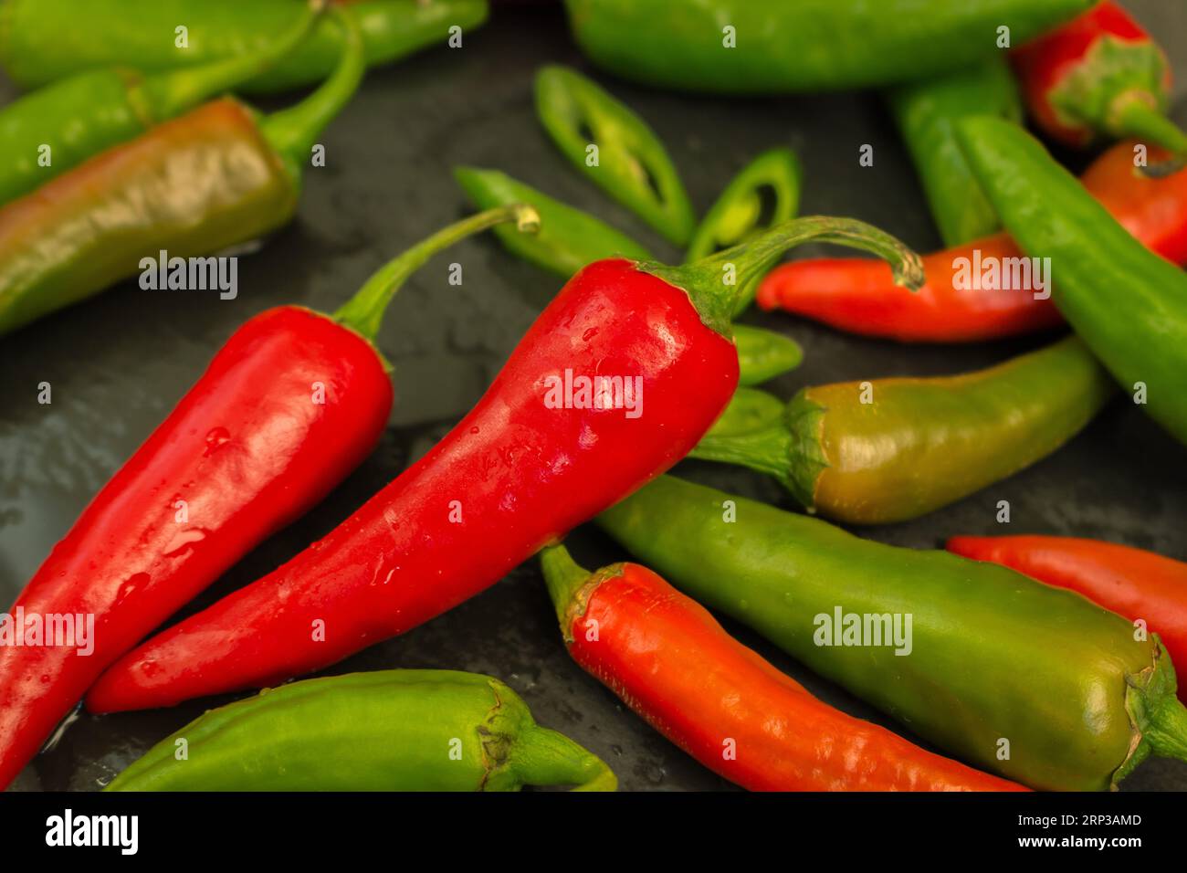 Red hot chilli peppers on black board with copy space. Heap of red and ...