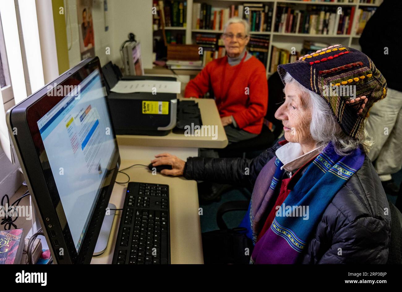Elderly retired women in a retirement home using computers to access ...