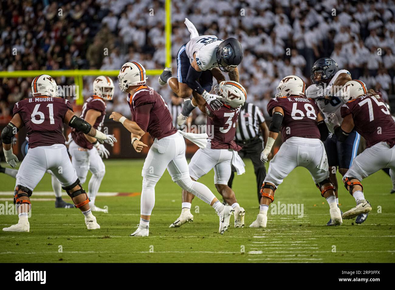 Old Dominion's Jason Henderson (42) (center) tries Bhayshul Tuten (33 ...