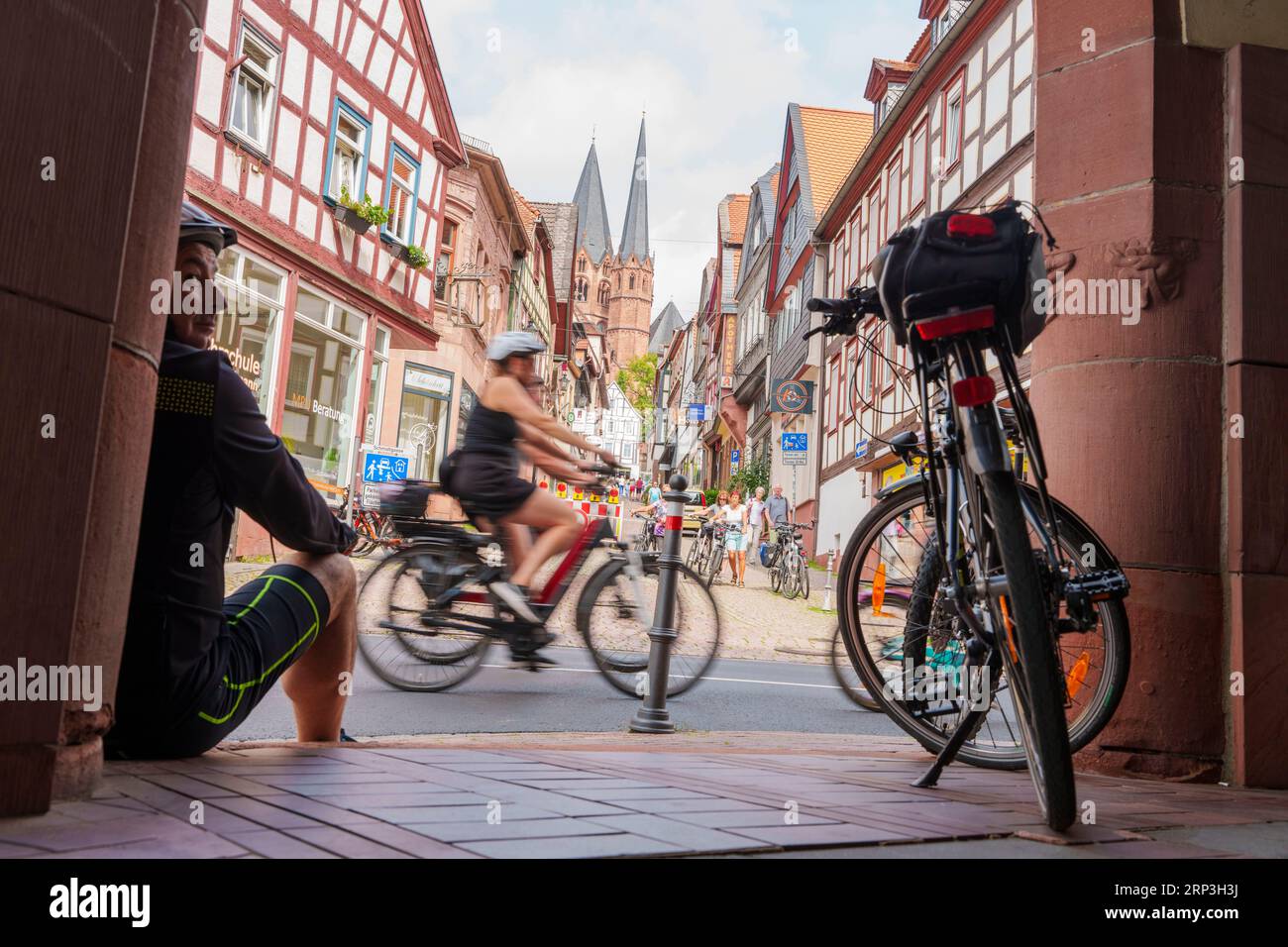 Gelnhausen, Germany. 03rd Sep, 2023. Cyclists ride past the historic ...
