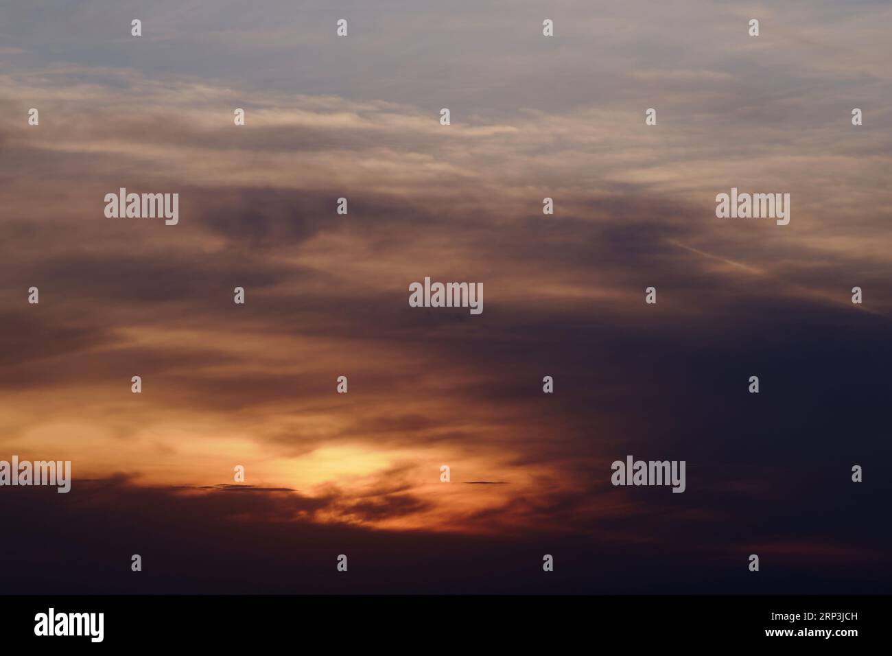 The large golden sun slowly sank below the horizon, leaving behind a ...