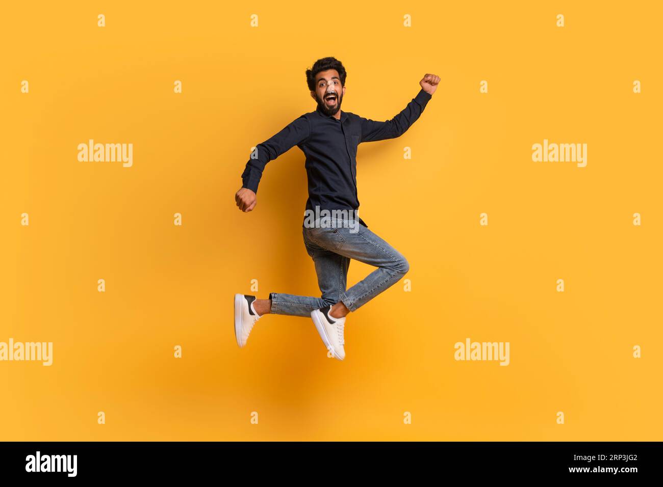 Happy Excited Indian Man Jumping In Air On Yellow Background Stock ...