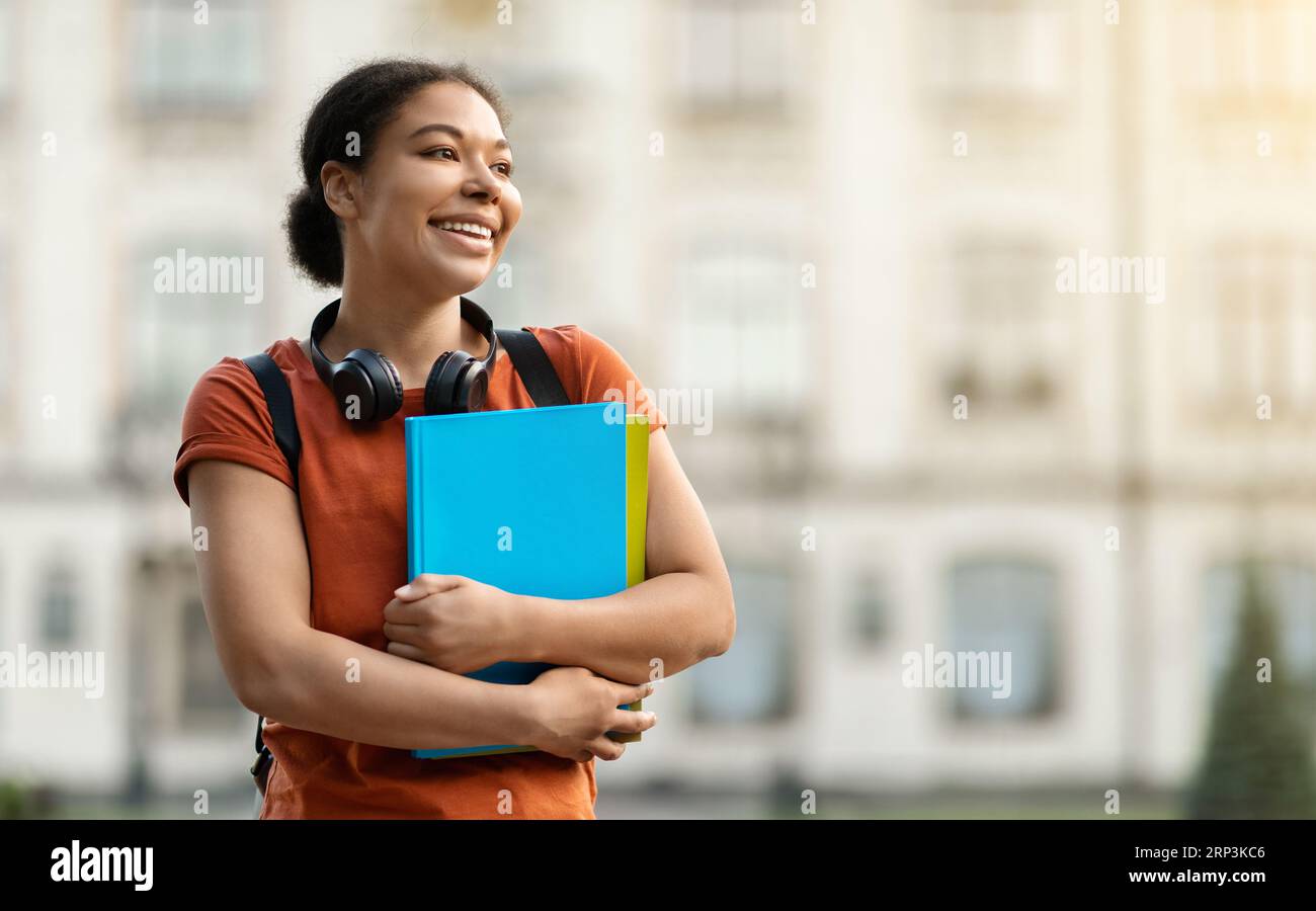 Portrait Of Beautiful Black Female Student With Workbooks Standing ...