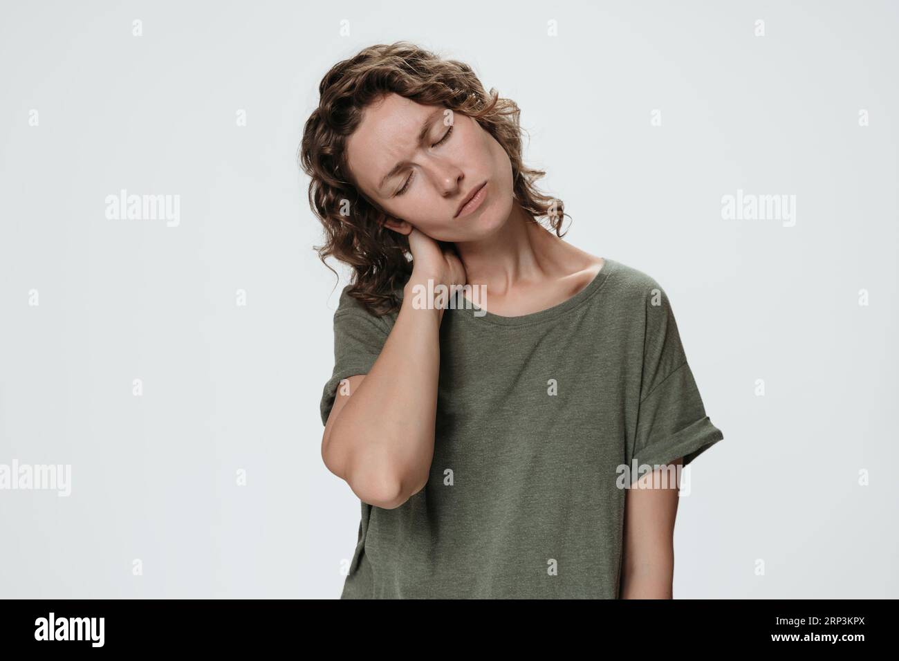 Tired sad young woman suffering from fatigued massaging hurt stiff neck ...