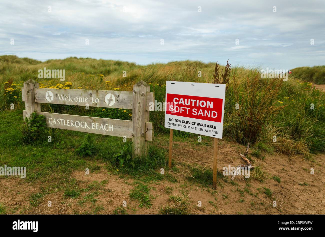 Welcome to Castlerock beach beside a soft sand warning sign Stock Photo ...
