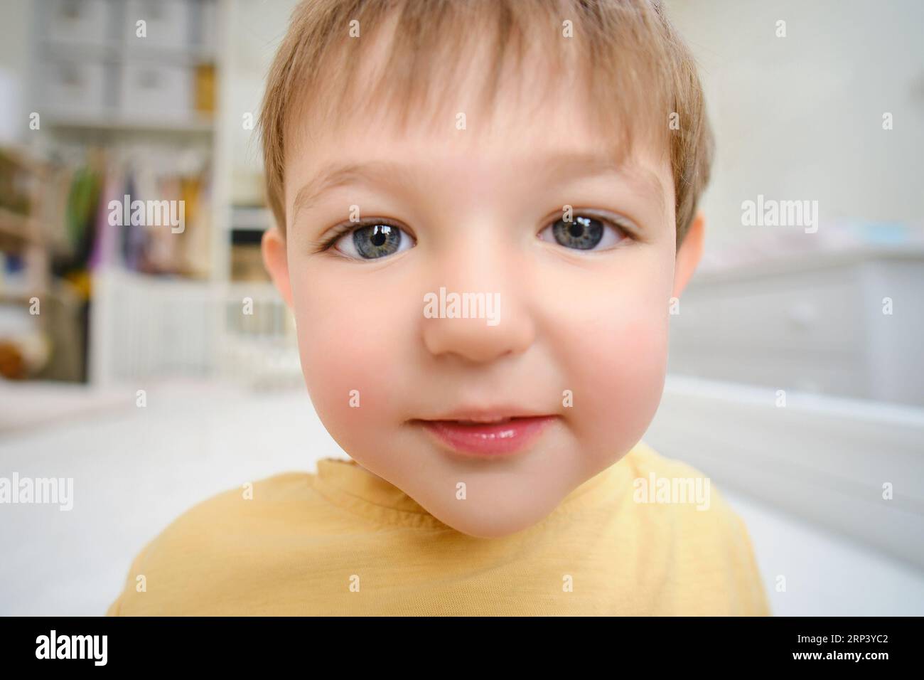Portrait of a baby in a home living room, close-up of a baby face. Kid ...