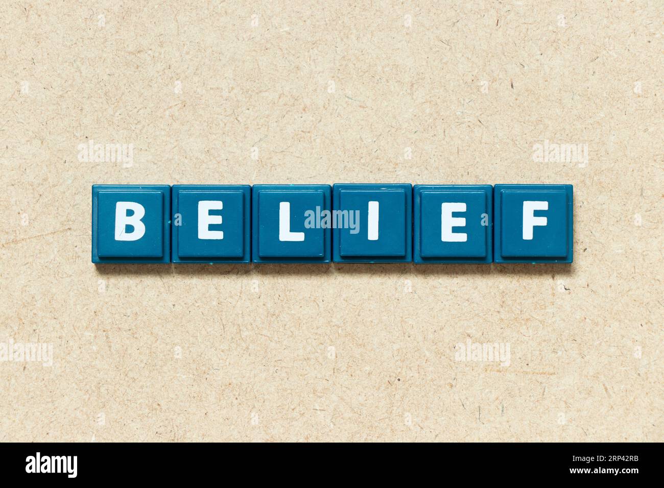 Tile alphabet letter in word belief on wood background Stock Photo - Alamy