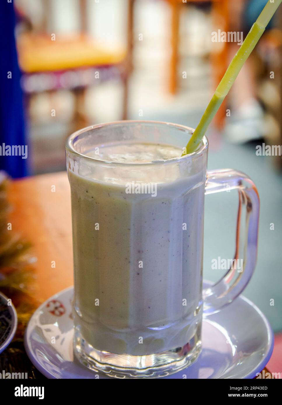 Closeup of a glass of Moroccan avocado milk shake placed on the dining ...