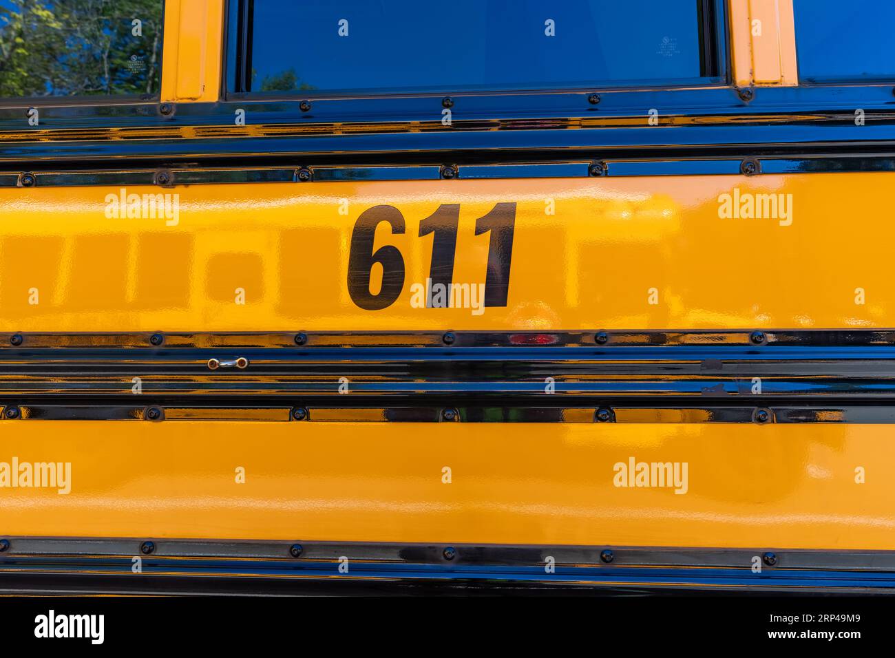 Side of a parked yellow school bus number 611 Stock Photo - Alamy
