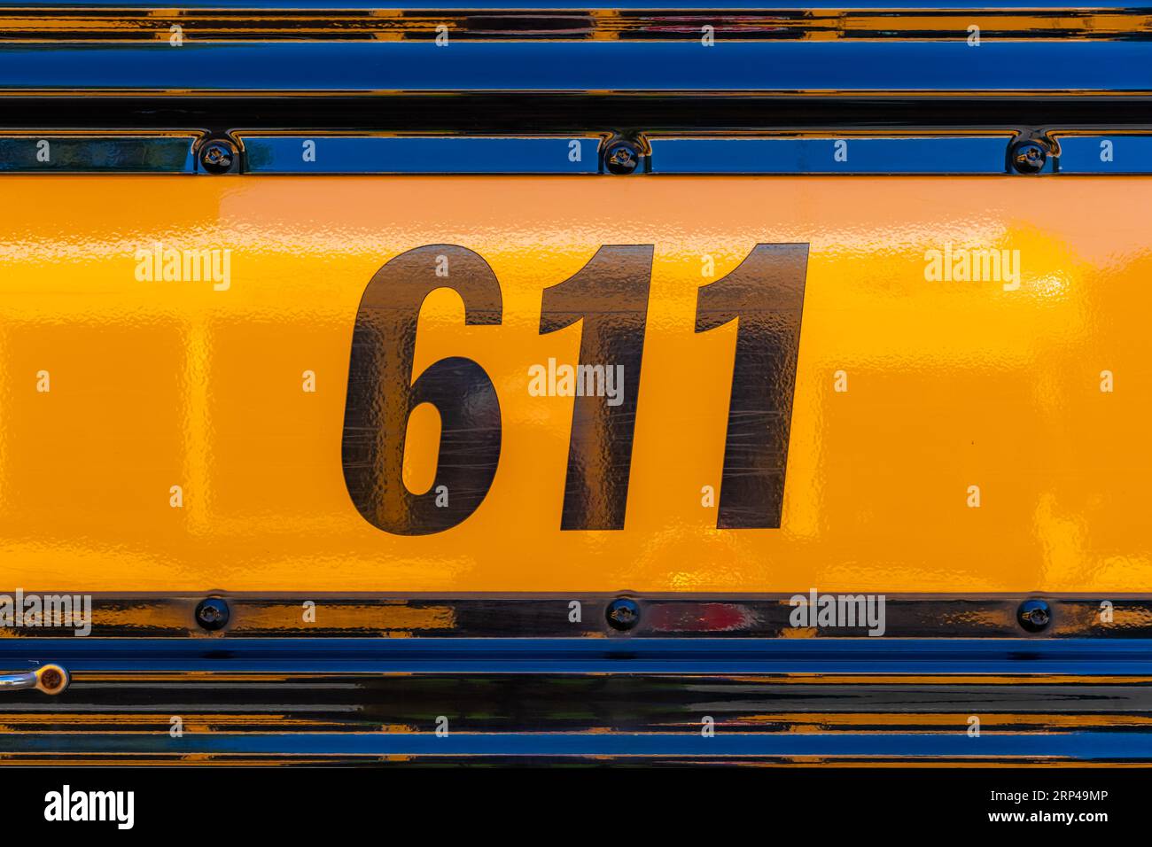 Side of a parked yellow school bus number 611 Stock Photo - Alamy