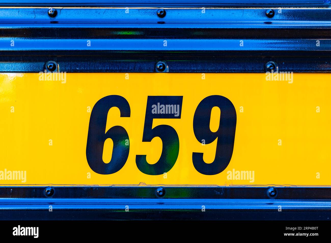 Side of a parked yellow school bus number 659 Stock Photo - Alamy