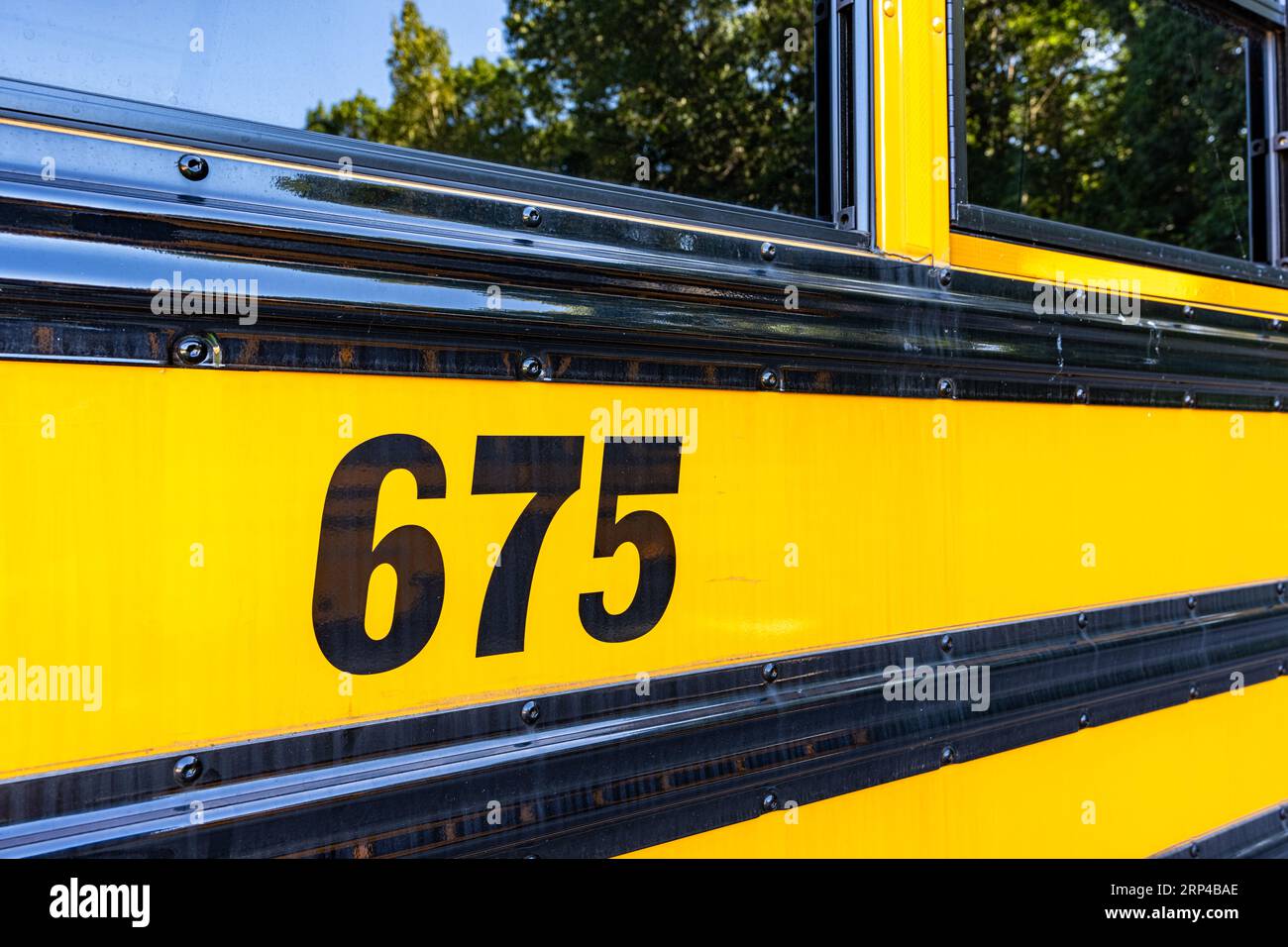 Side of a parked yellow school bus number 675 Stock Photo - Alamy