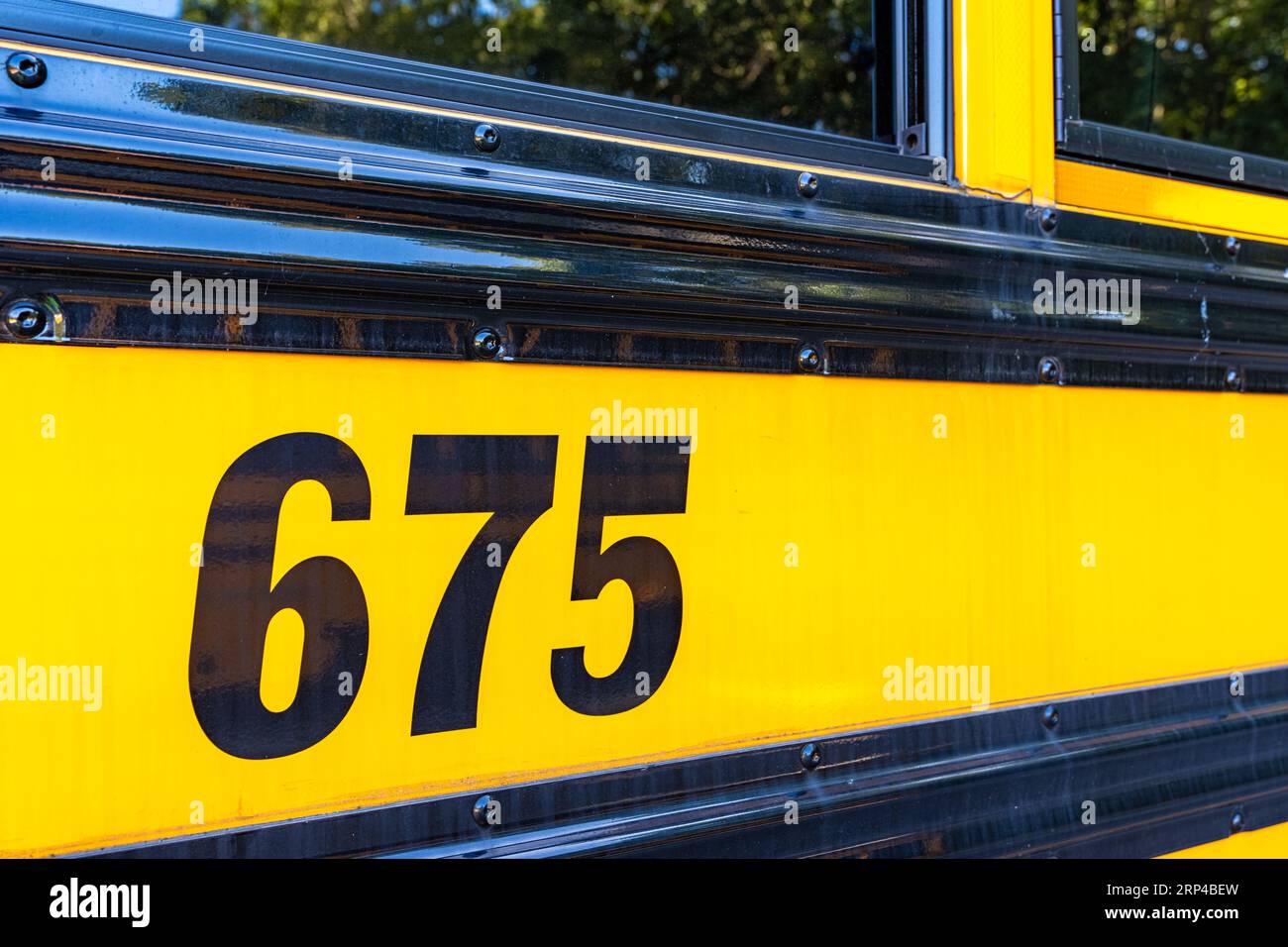 Side of a parked yellow school bus number 675 Stock Photo - Alamy