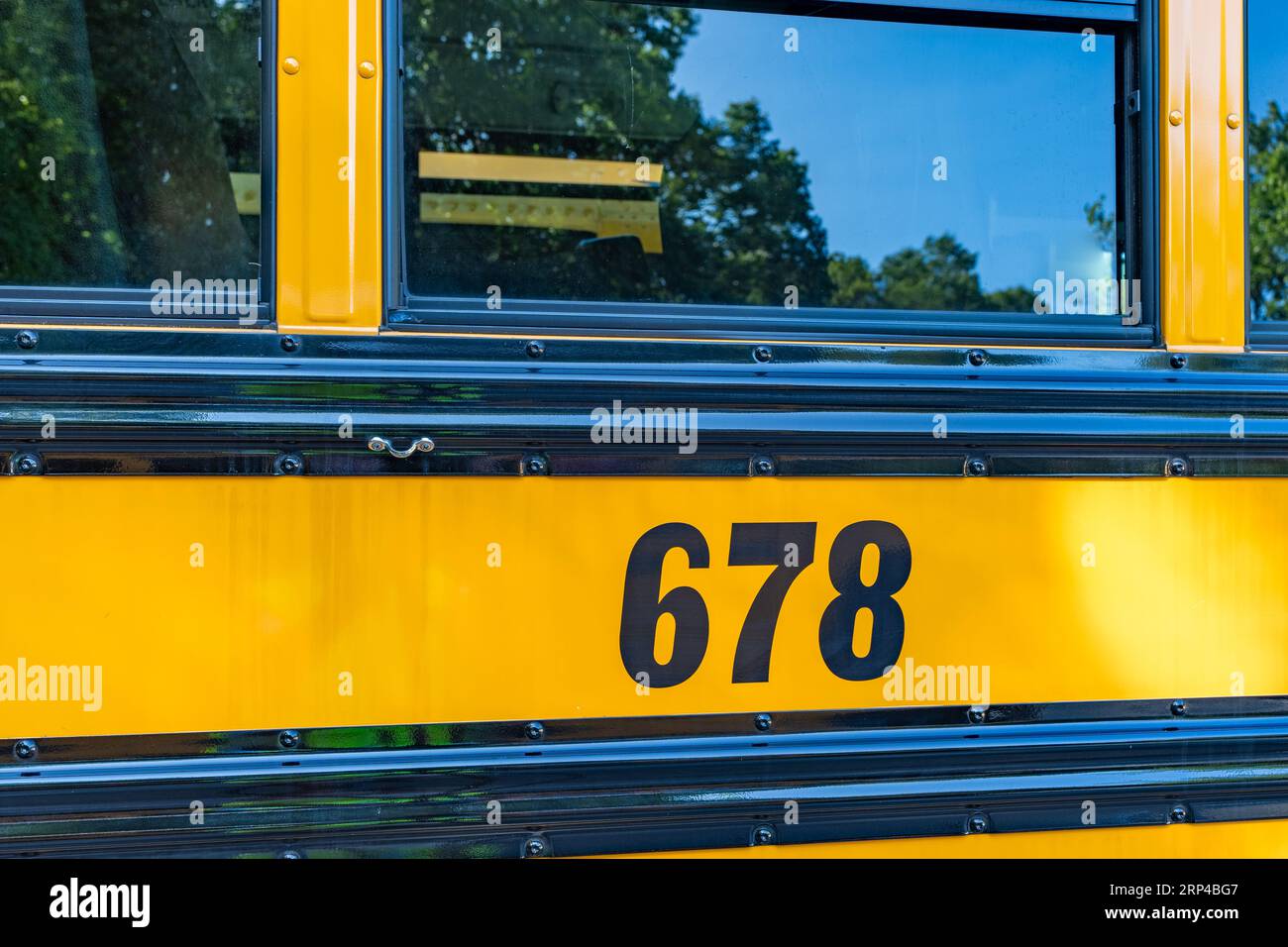 Side of a parked yellow school bus number 678 Stock Photo - Alamy