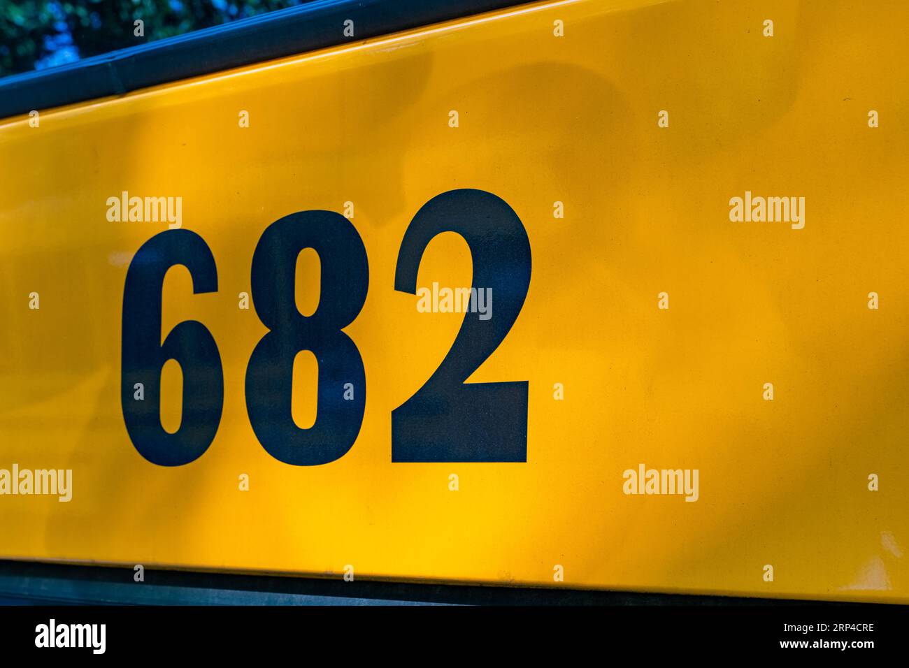 Back of a parked yellow school bus number 682 Stock Photo - Alamy