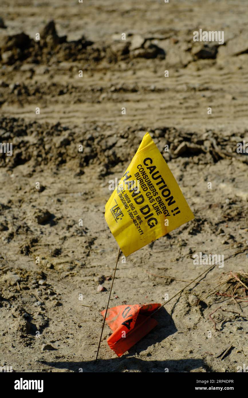 Flag warning to hand dig due to buried natural gas line Stock Photo - Alamy