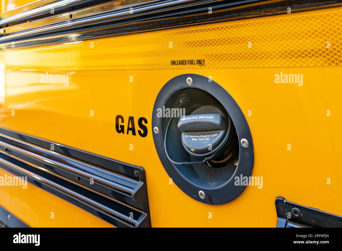 Gas cap on the side of a parked yellow school bus Stock Photo - Alamy