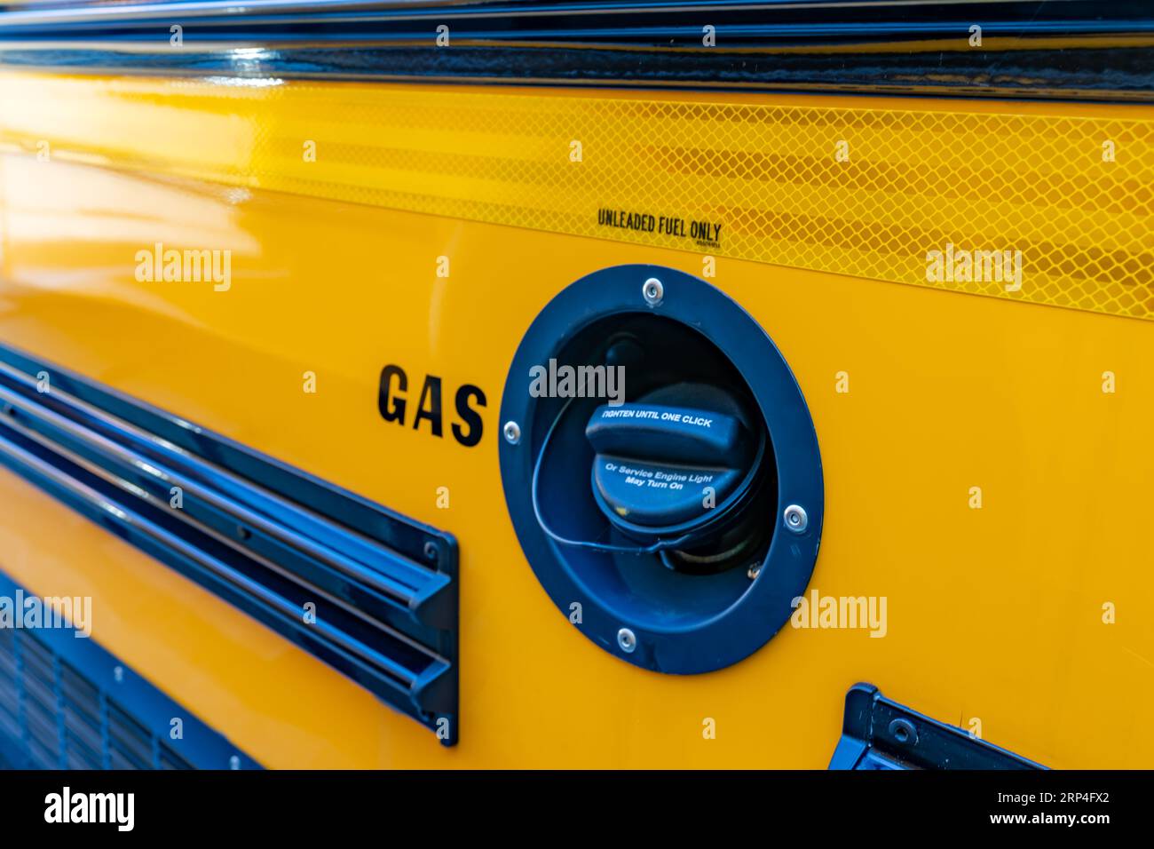 Gas cap on the side of a parked yellow school bus Stock Photo - Alamy