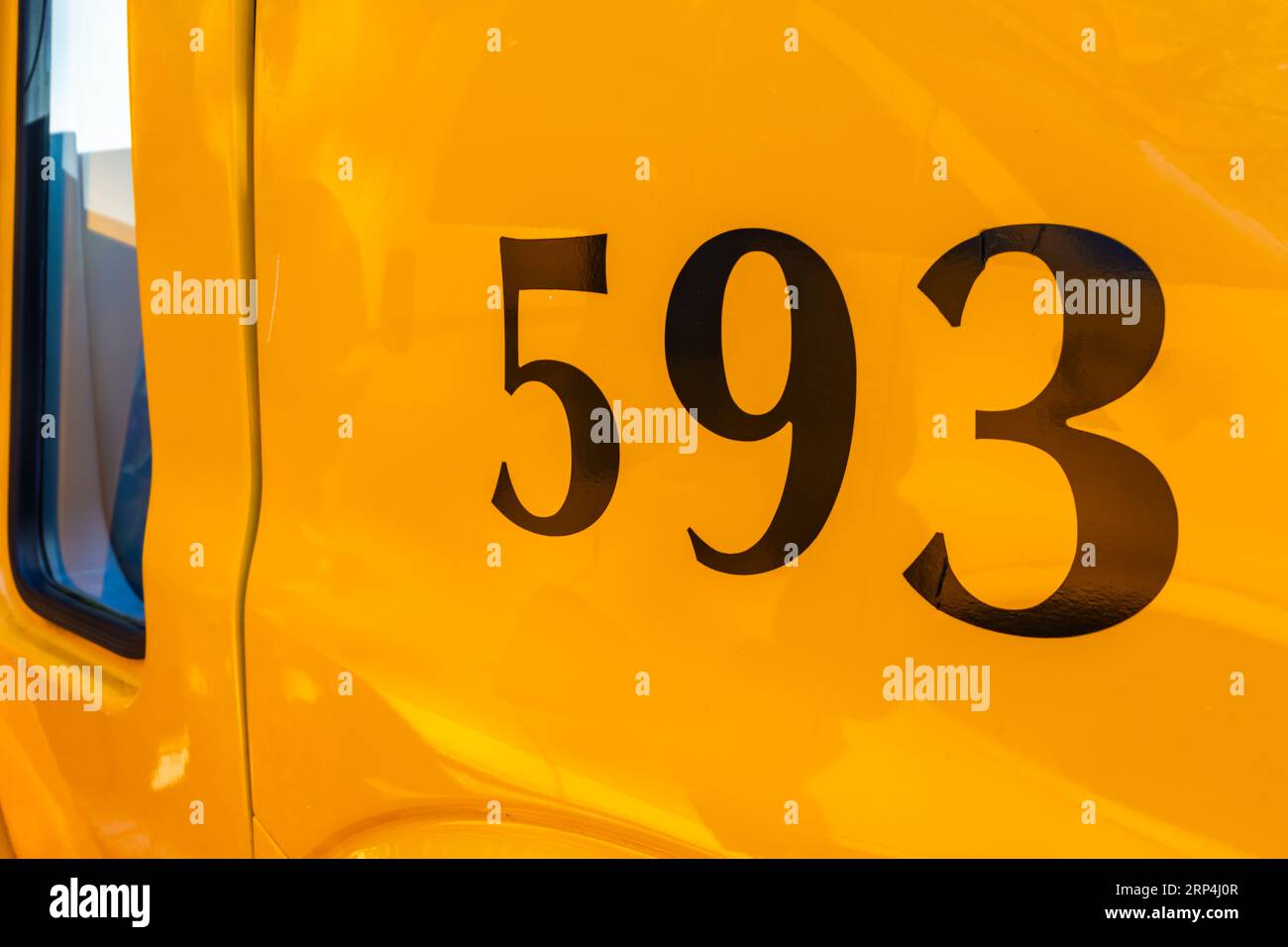 Side of a parked yellow school bus number 593 Stock Photo - Alamy