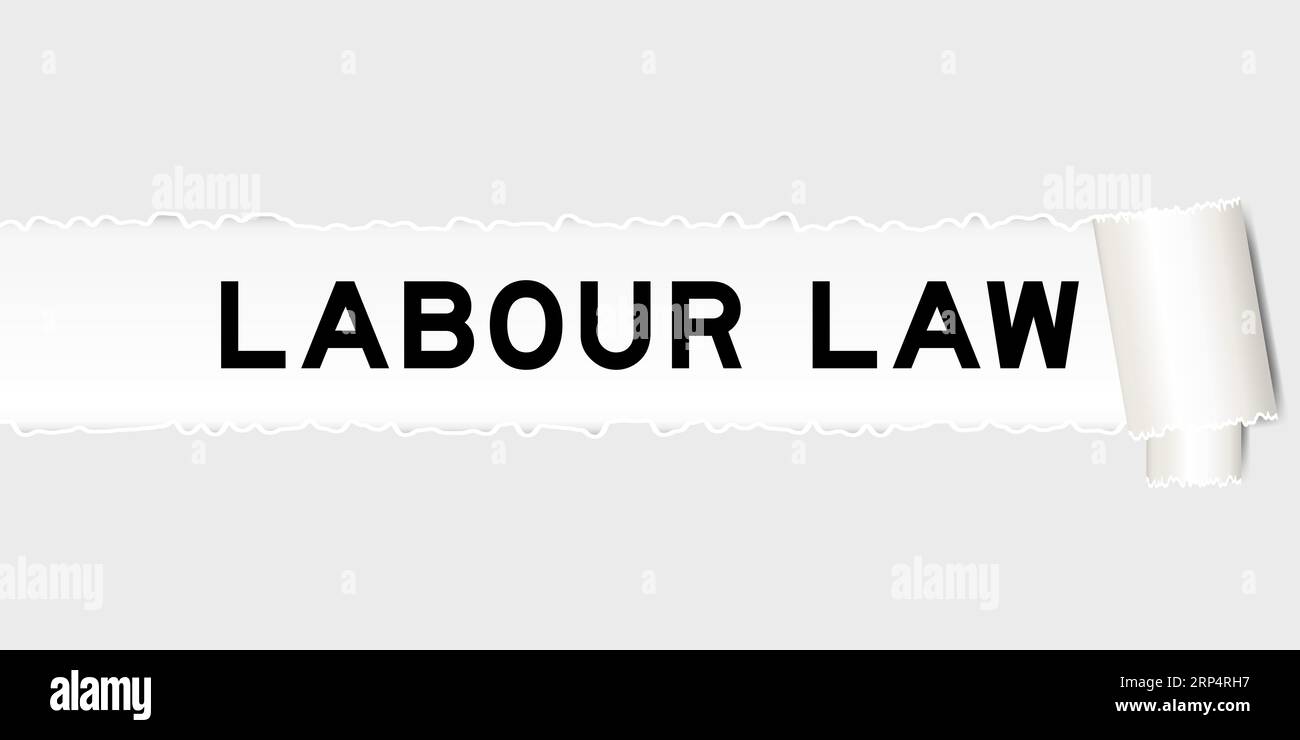 Ripped gray paper background that have word labour law under torn part ...