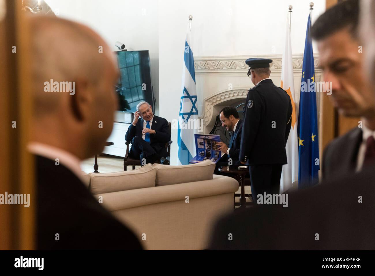 Cypriot President Nikos Christodoulides, right background, and Israeli ...
