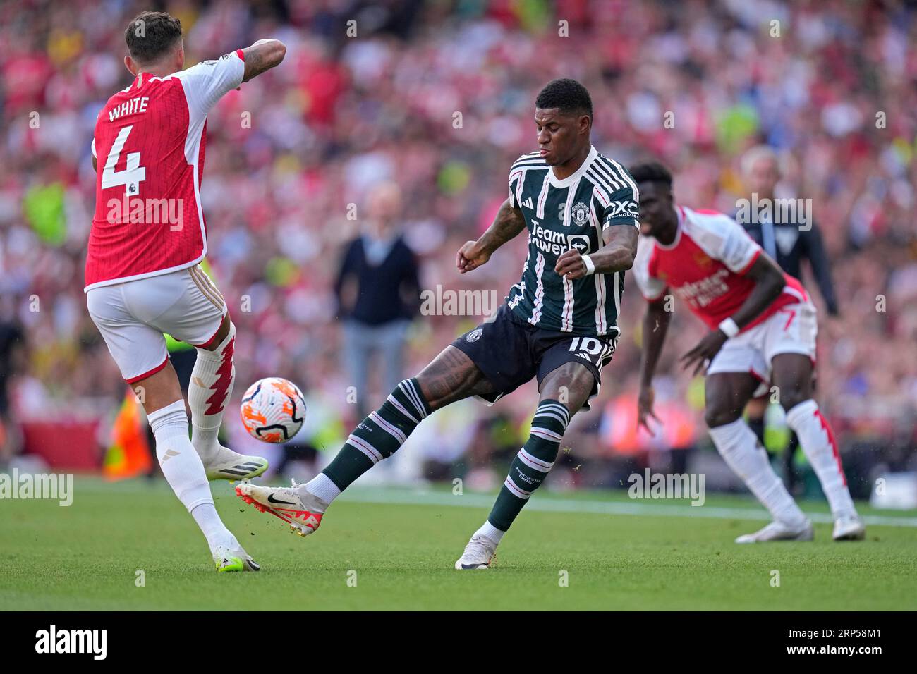 Manchester United's Marcus Rashford is challenged by Arsenal's Ben ...