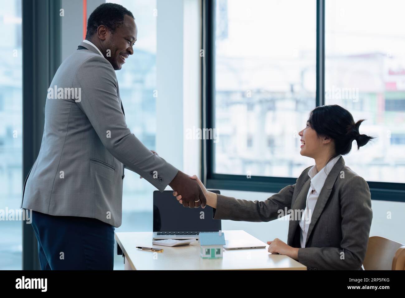 Real Estate Agent and client handshake after signing a contract success ...