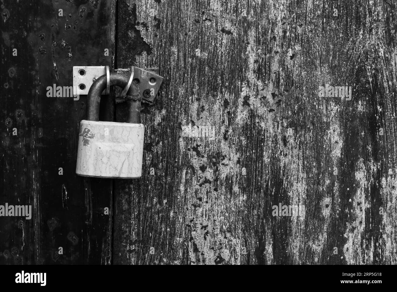 Old rusty lock on metal doors. Lock on the door with an empty place for ...